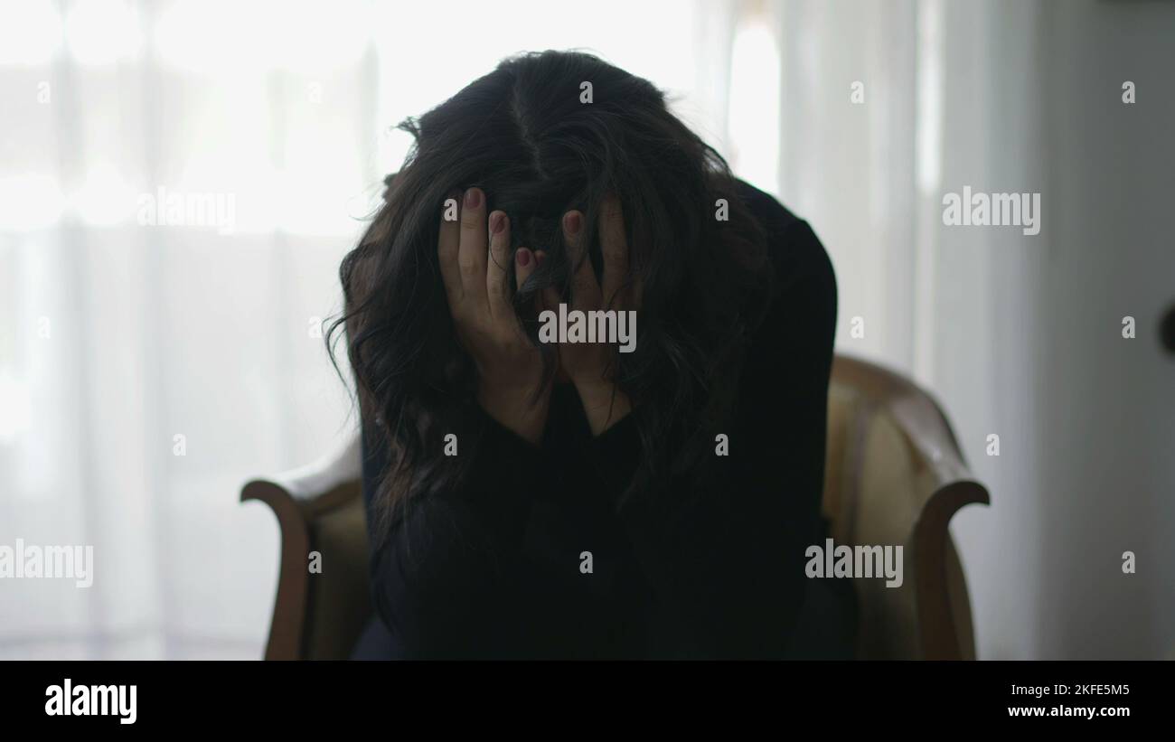 Woman covering face in shame suffering from emotional pain Stock Photo ...