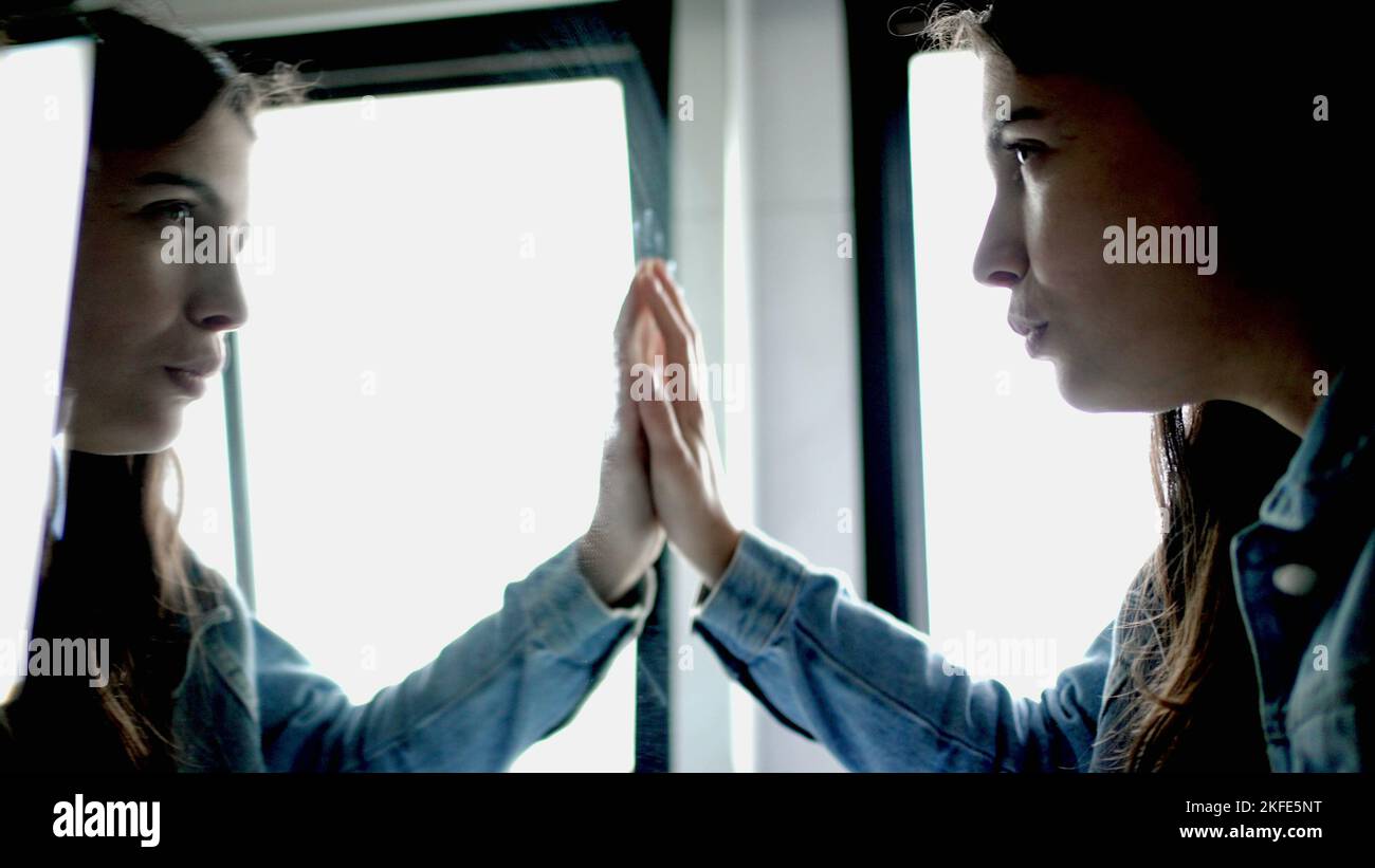 Woman looking at mirror reflection facing your fears concept Stock ...