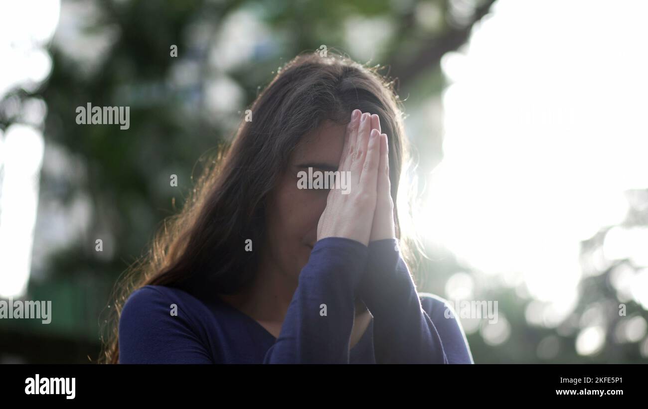 Woman praying outside looking up at sky with HOPE and FAITH. Spiritual ...