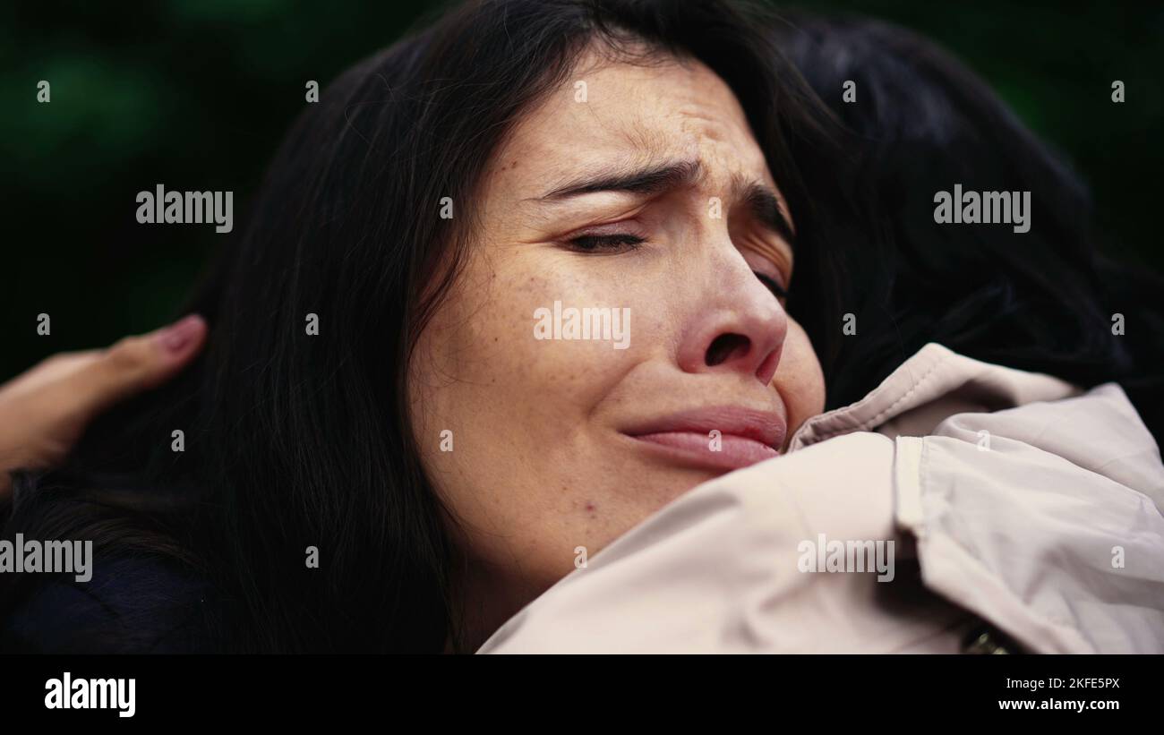 Sorrowful woman closeup face with negative emotion hugging friend Stock ...