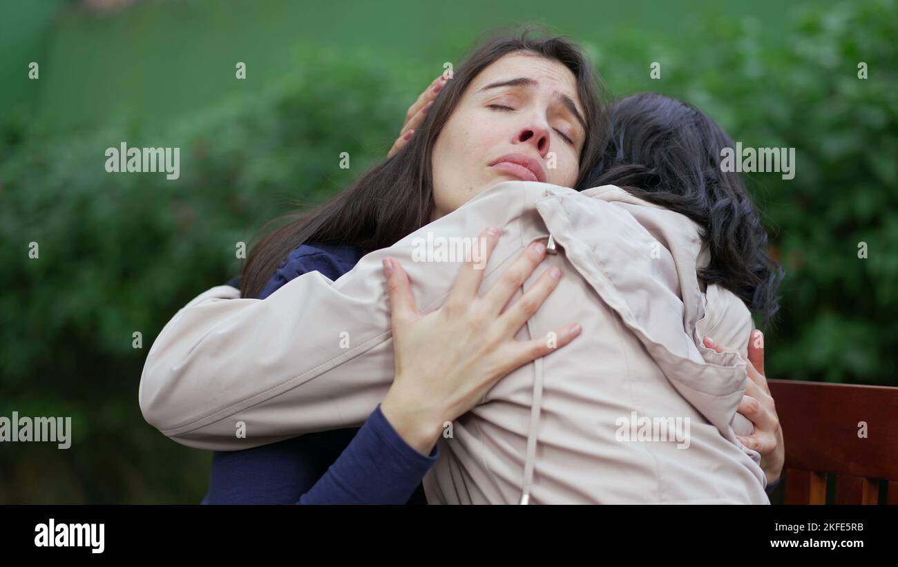 Sad woman suffering from negative emotion. Two women embracing each ...