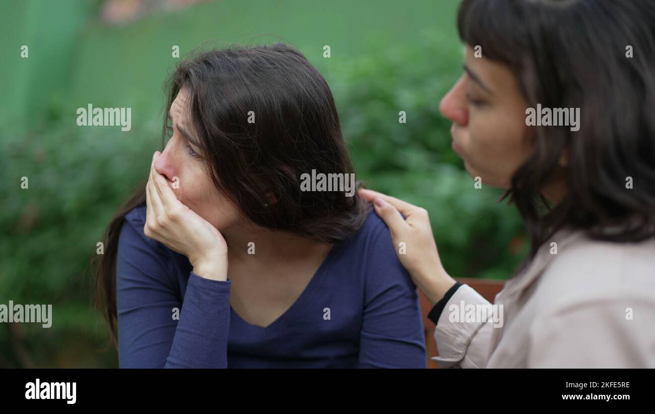 Sad woman suffering from negative emotion. Two women embracing each ...