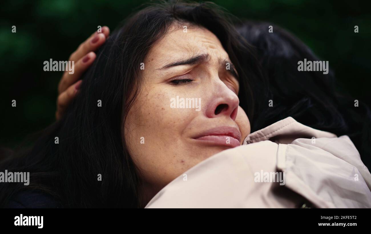 Sorrowful woman closeup face with negative emotion hugging friend Stock ...