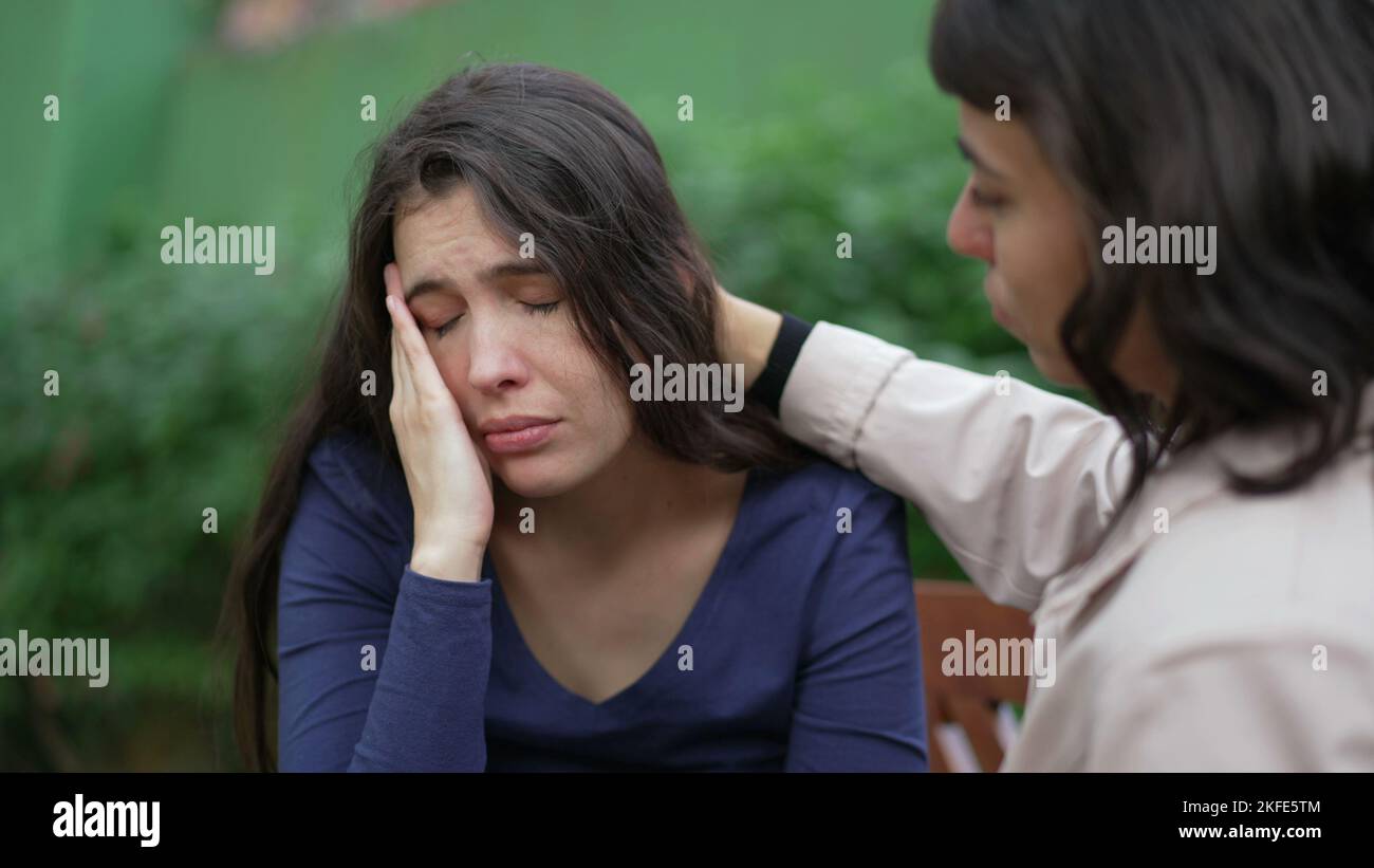 Sad woman suffering from negative emotion. Two women embracing each ...
