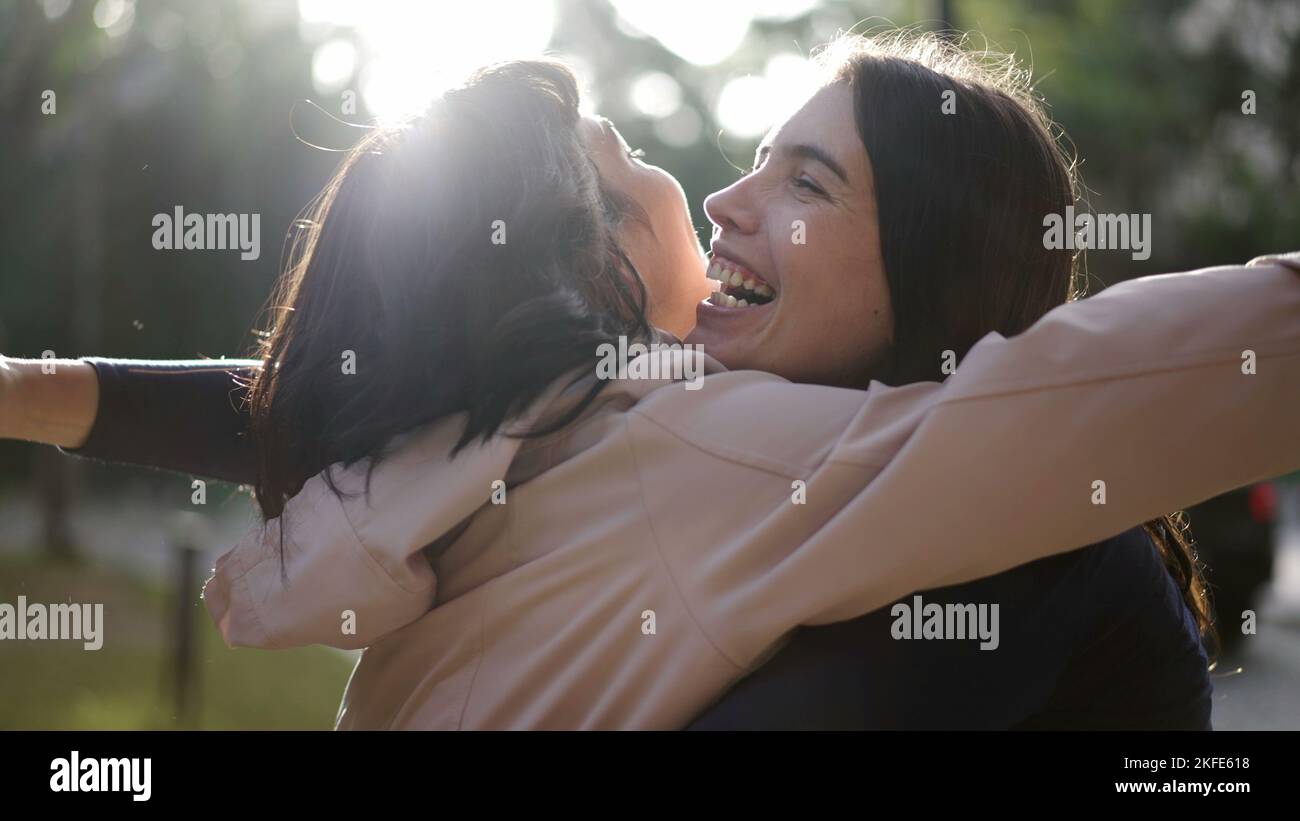 Two happy female best friends hugging each other. Women embrace reunion ...