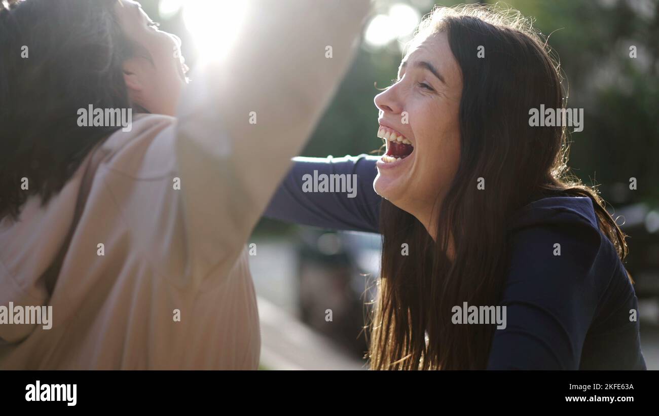 Two happy female best friends hugging each other. Women embrace reunion ...