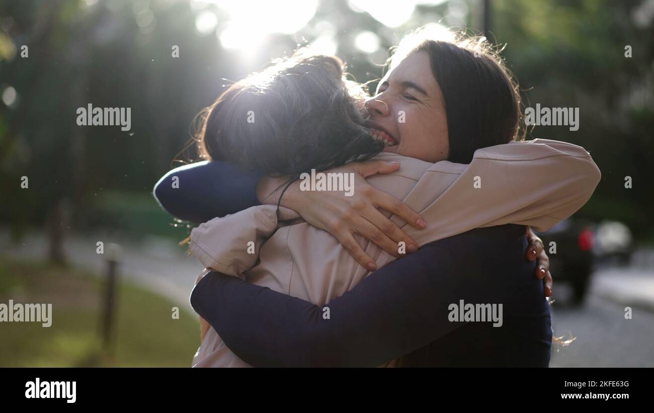 Two happy female best friends hugging each other. Women embrace reunion ...