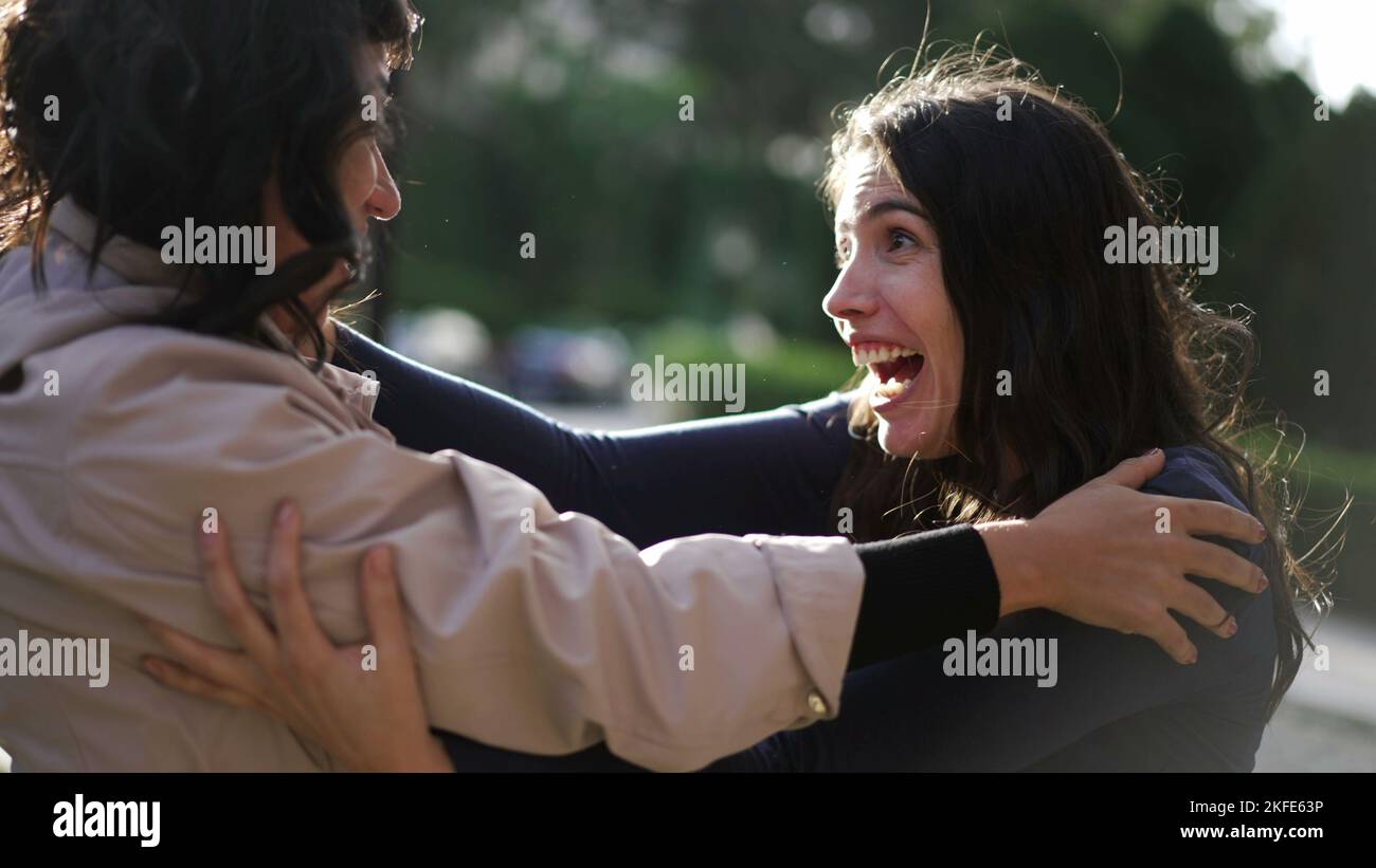 Two happy female best friends hugging each other. Women embrace reunion ...