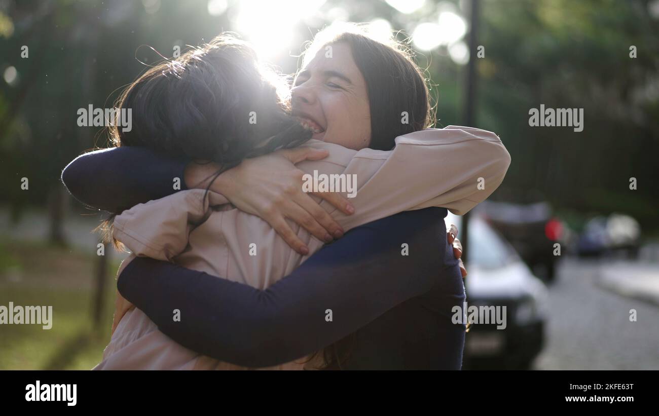 Two happy female best friends hugging each other. Women embrace reunion ...