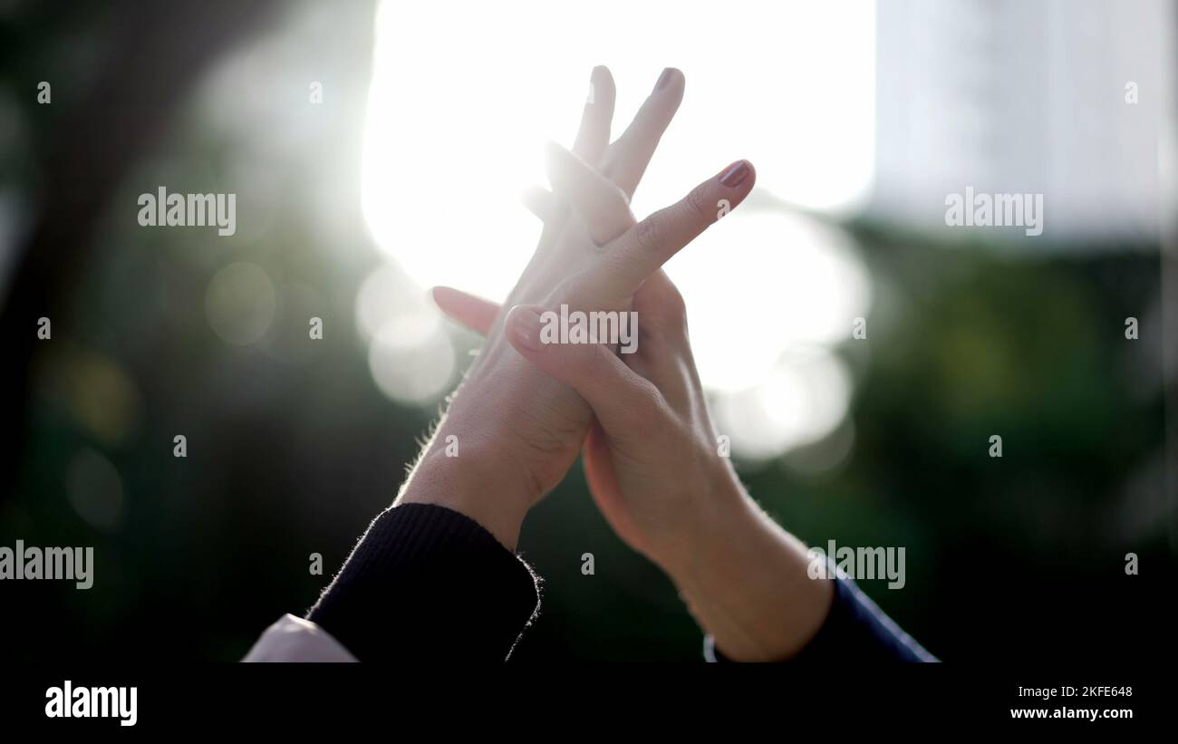 Two people holding hands together in union. Women physical connection ...