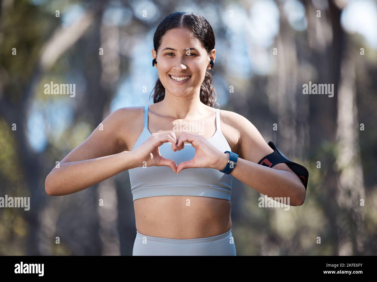 Fitness, heart hands sign or portrait of woman outdoor running in ...