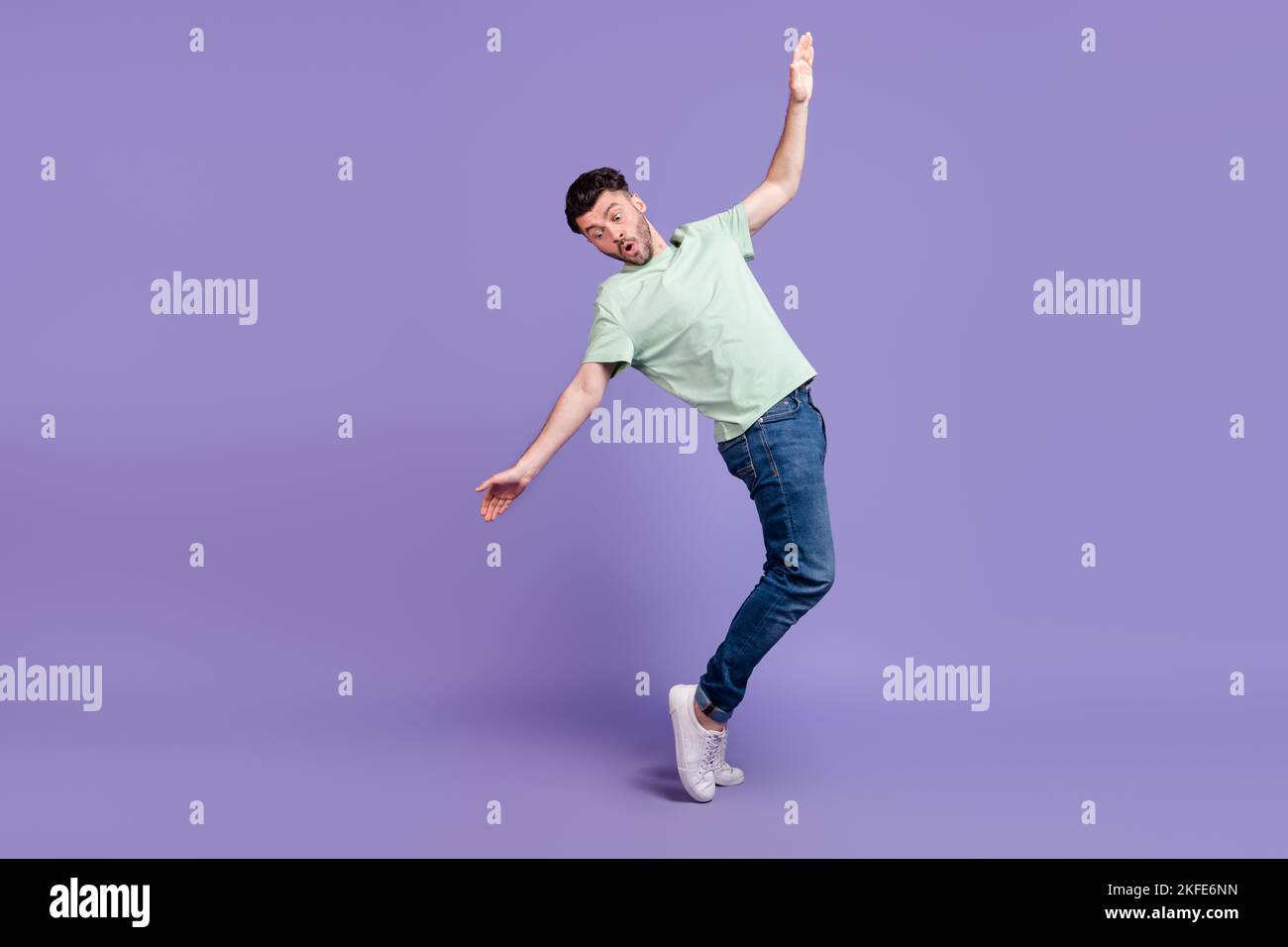 Full length photo of frightened crazy impressed man stand toes look ...