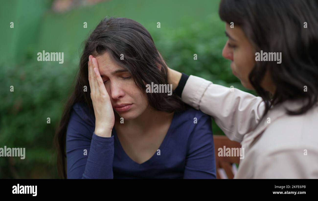 Depressed woman suffering with the help and support of female friend ...