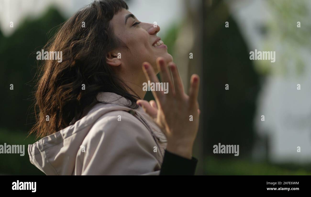 Evangelical South American woman standing outside feeling the presence ...