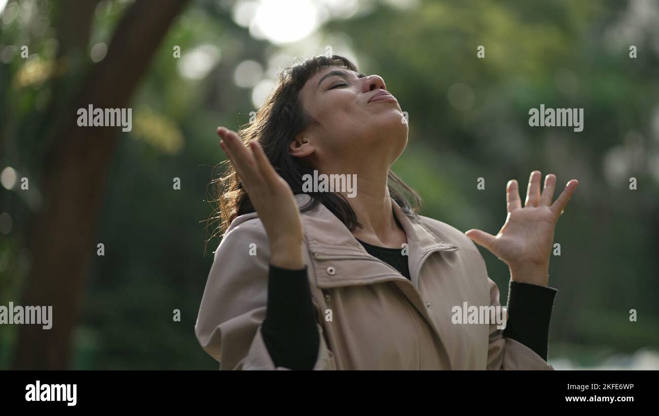 Evangelical South American woman standing outside feeling the presence ...