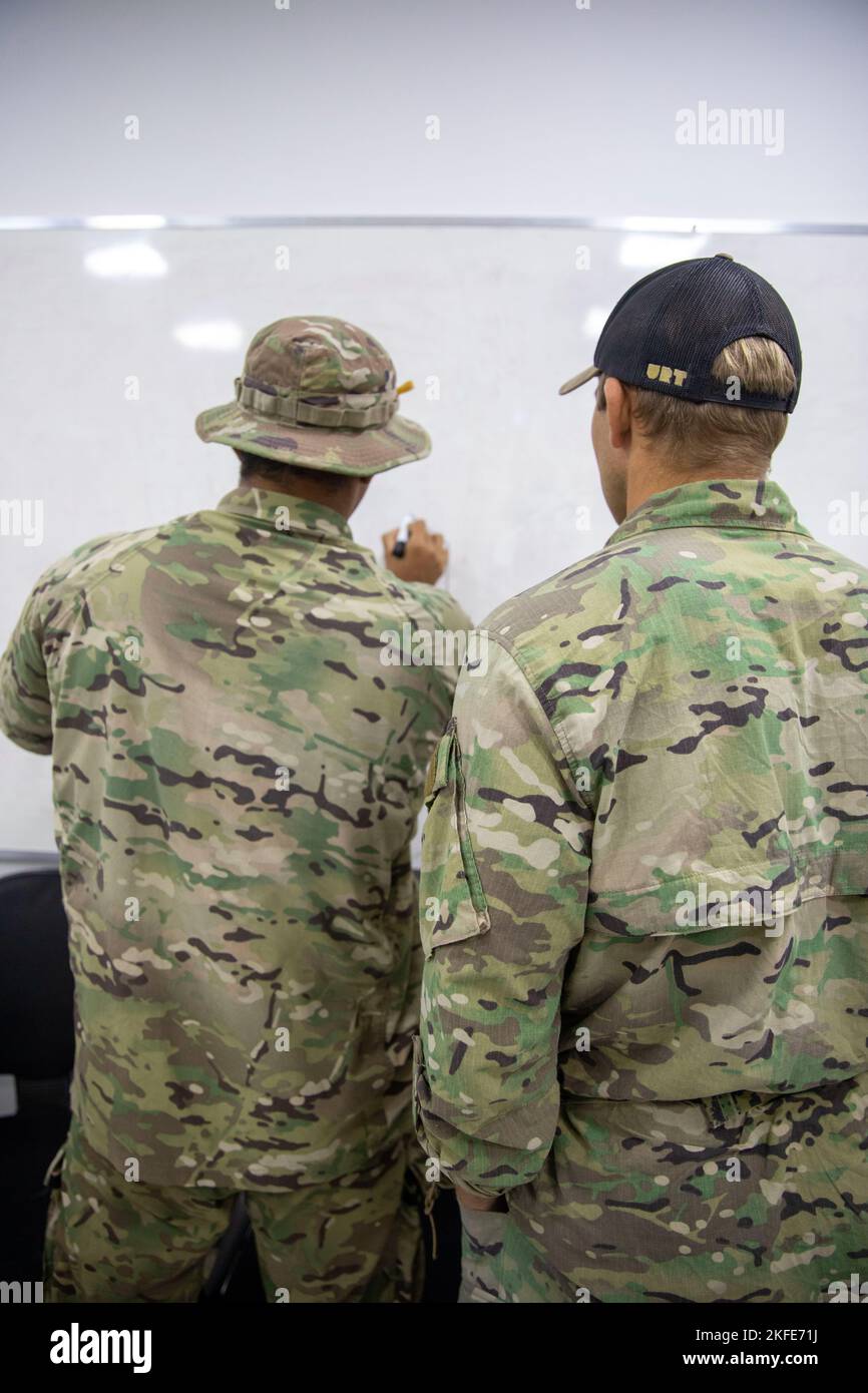 U.S. Navy SEALs assigned to a Naval Special Operations Team, plan prior ...