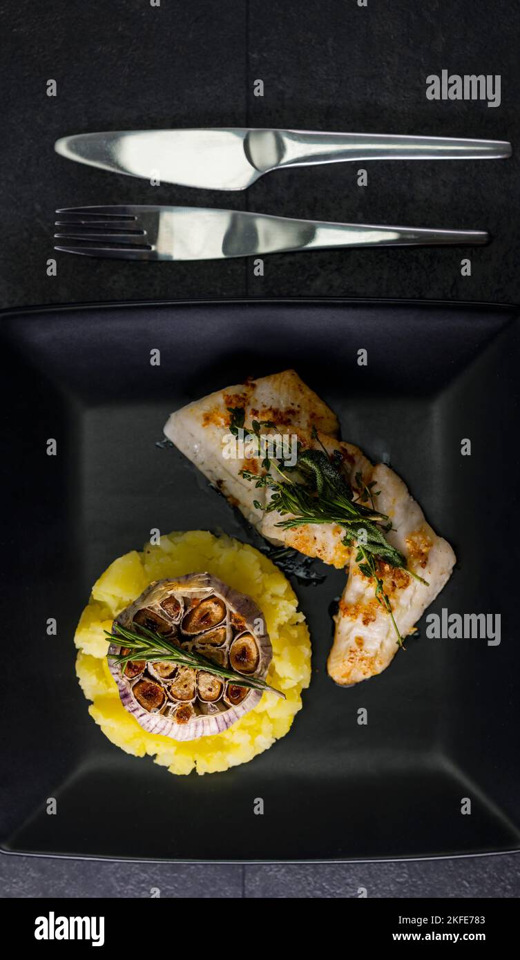 cod fillet with couscous and roasted garlic Stock Photo - Alamy