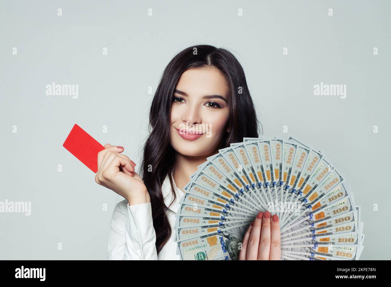 Successful business woman showing red empty card and fan of us dollars ...