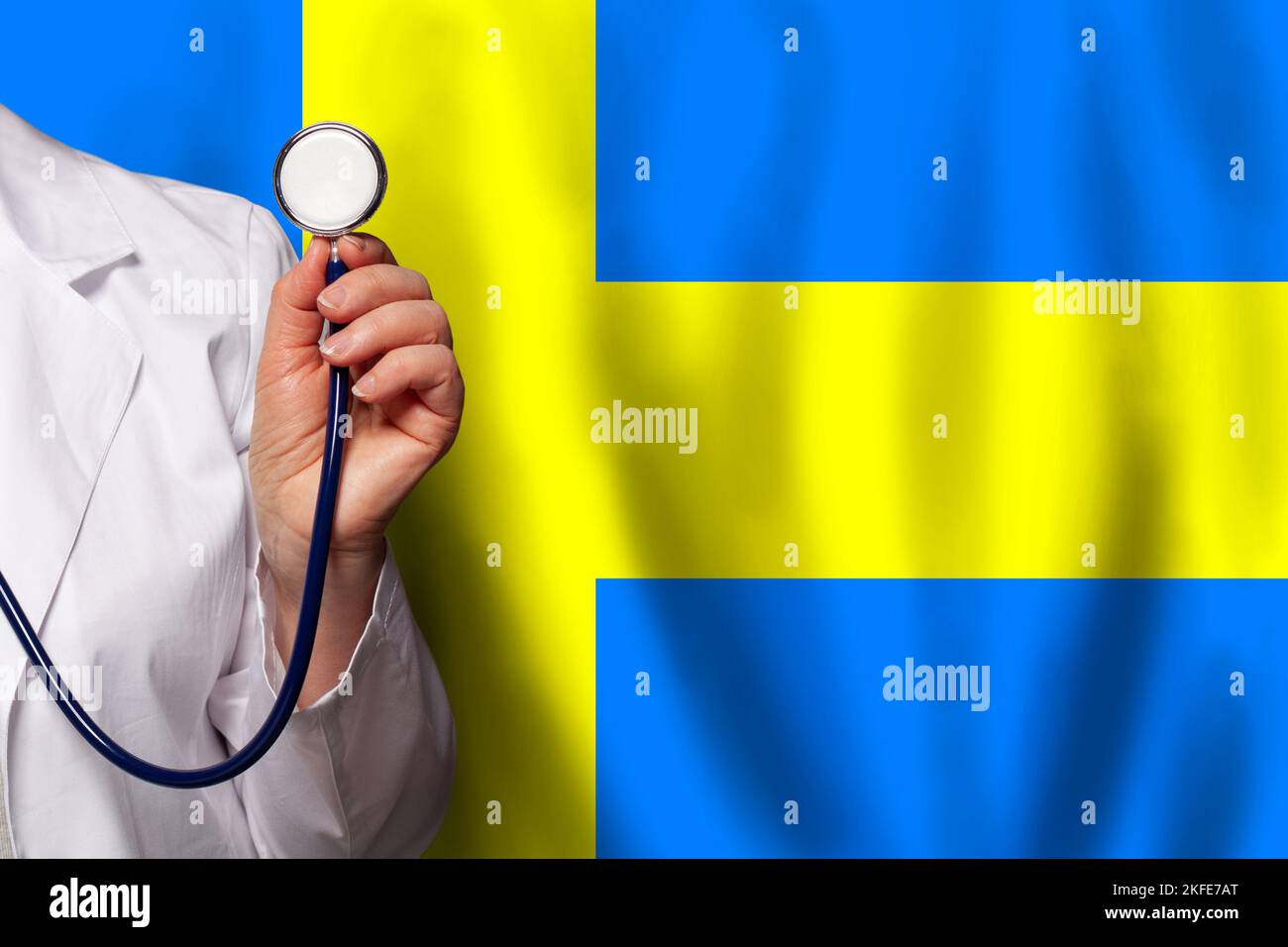 Swedish medical worker's hand with stethoscope on flag of Sweden ...
