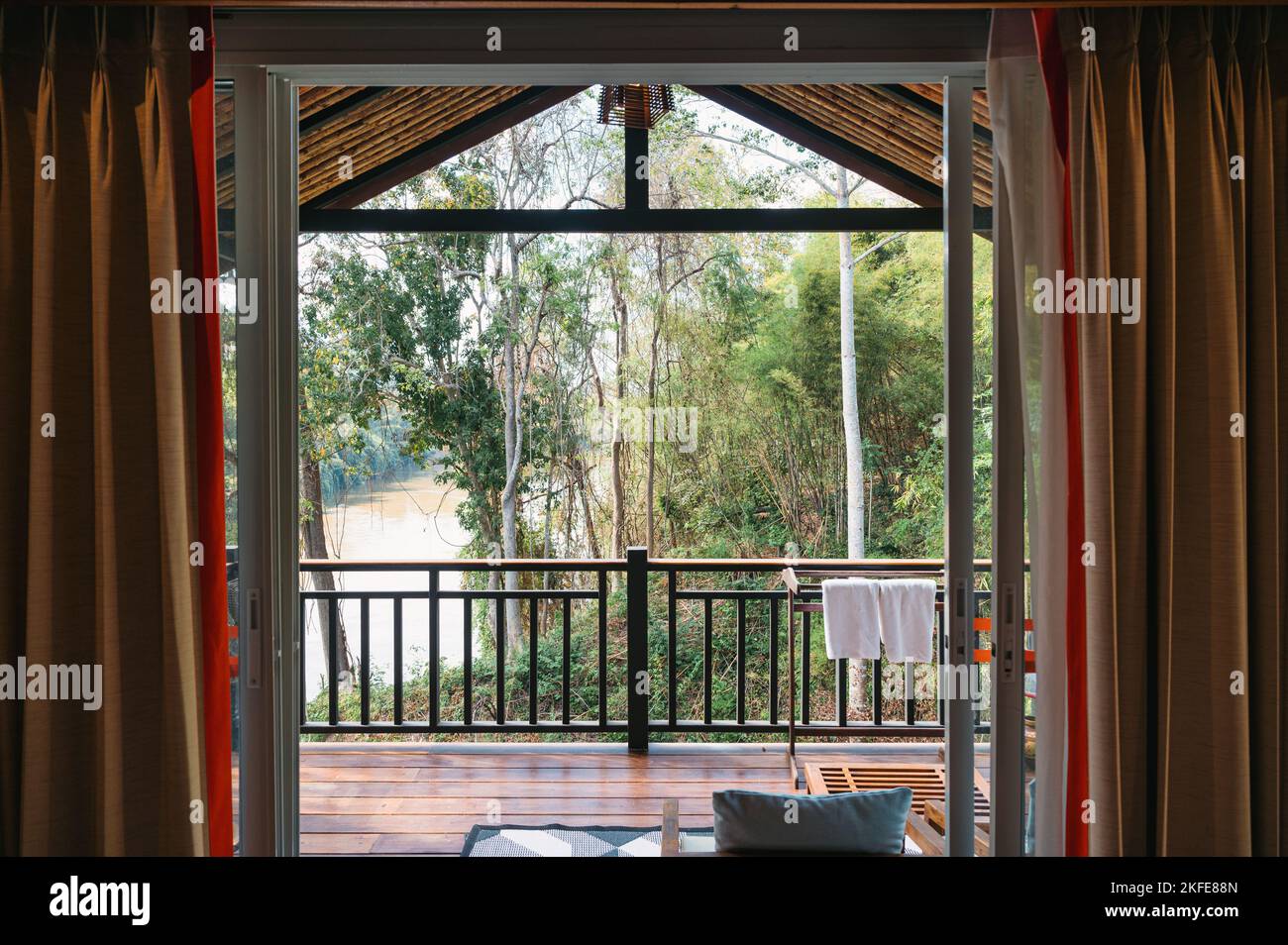 Tropical rainforest and river view from wooden balcony of the resort on ...