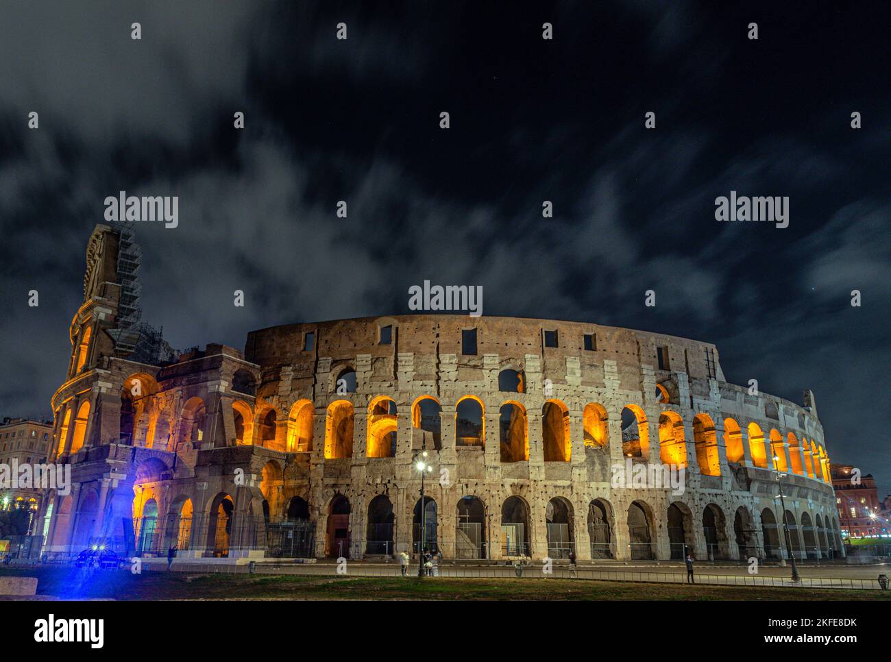The Coliseum amphitheater at night with a dramatic cloudy sky in the ...