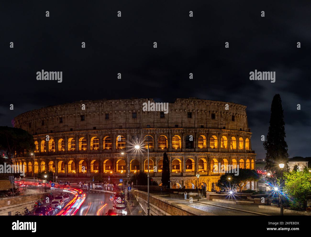 The Coliseum amphitheater at night with a dramatic cloudy sky in the ...