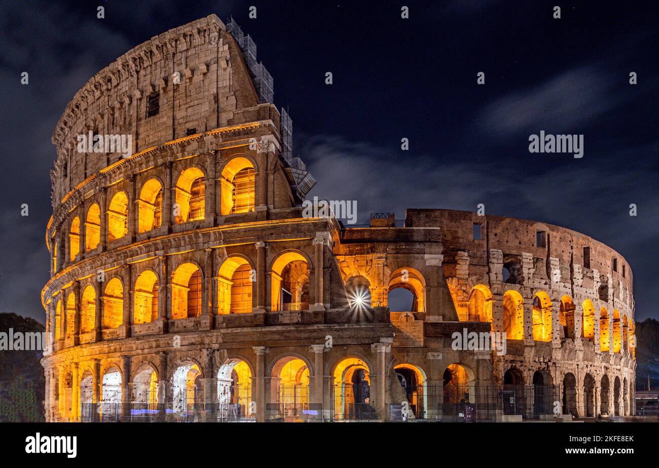 The Coliseum amphitheater at night with a dramatic cloudy sky in the ...