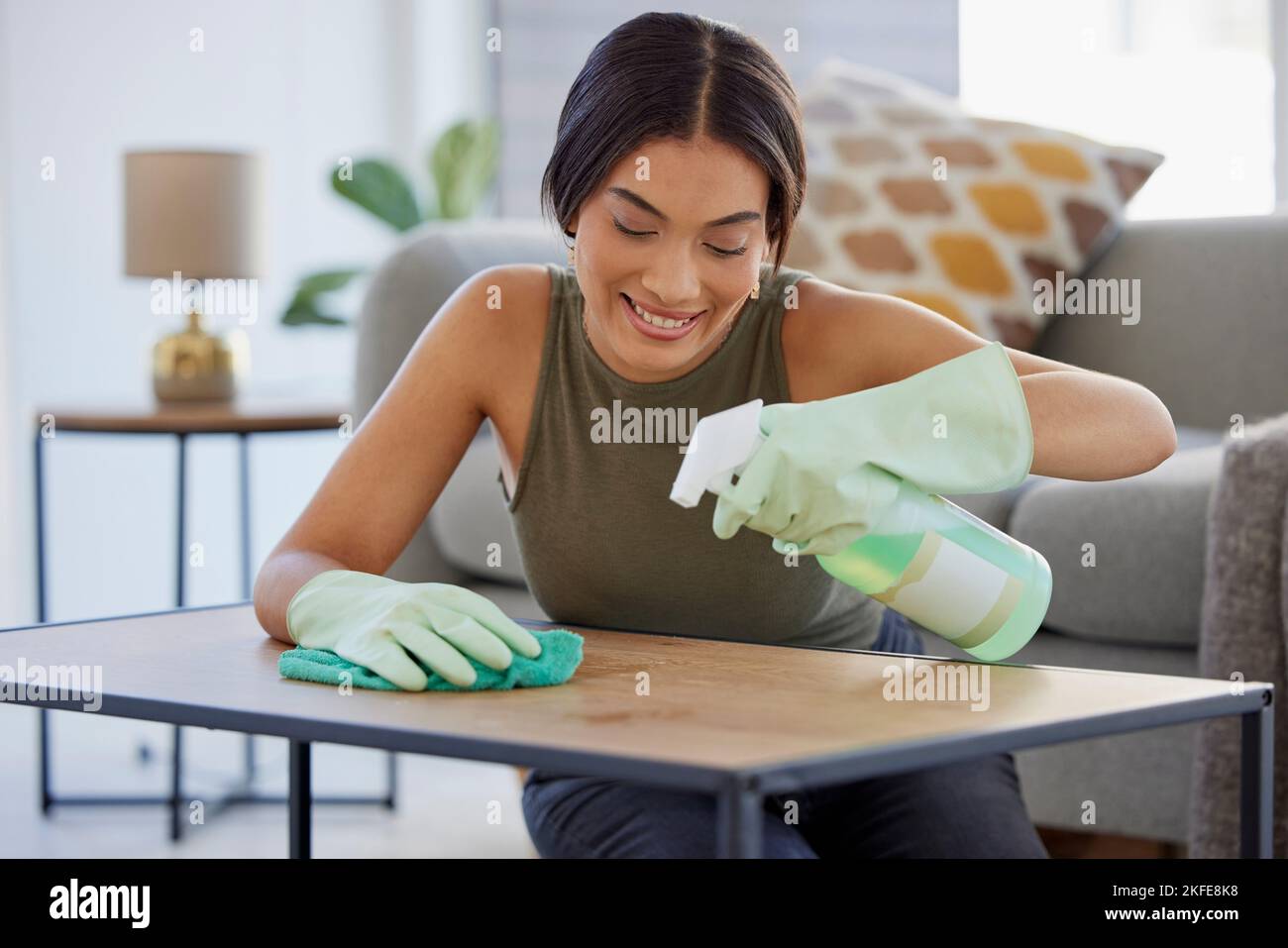 Woman, detergent and smile for cleaning table, hygiene or sanitary ...