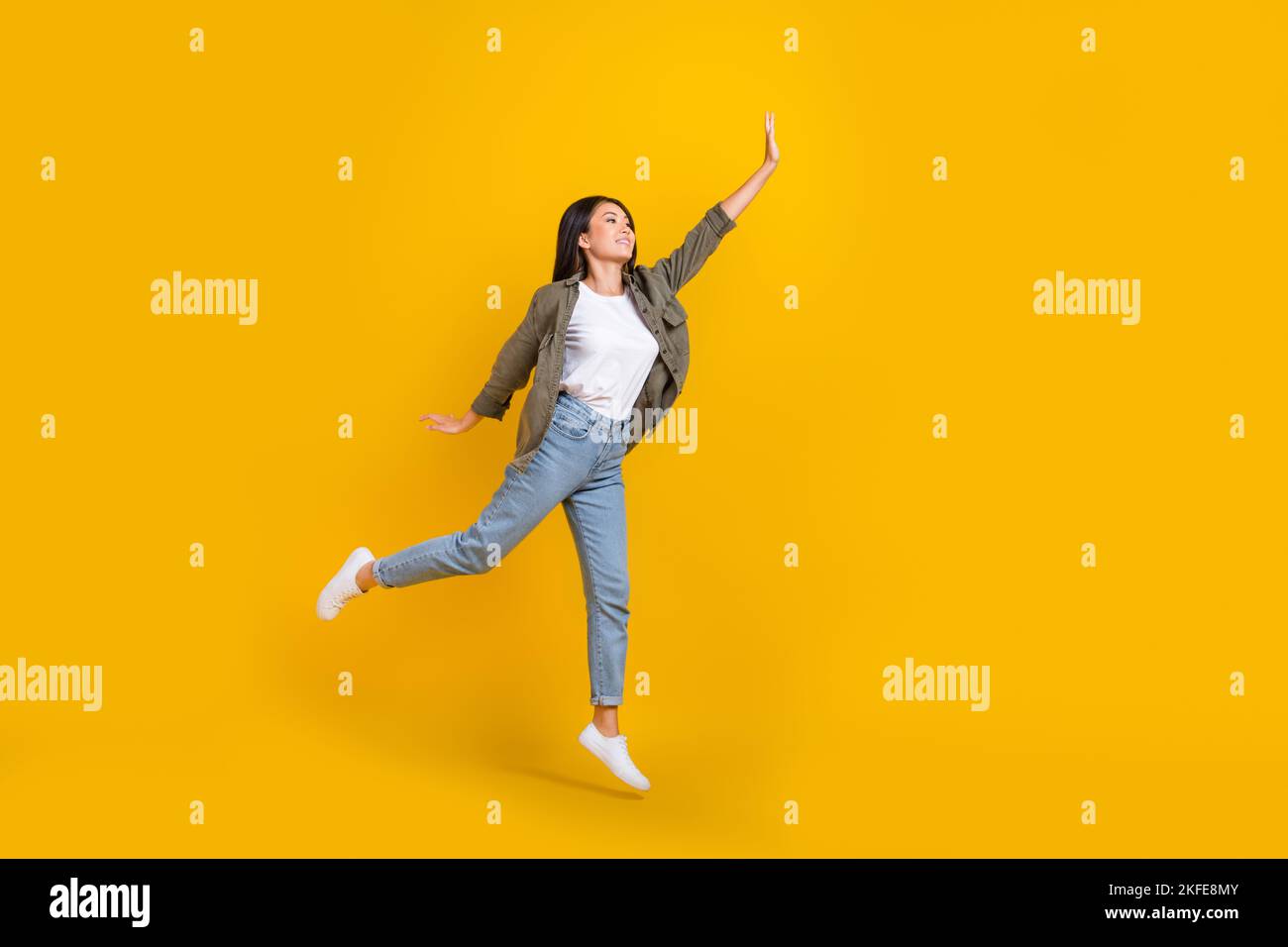 Full length photo of young japanese businesswoman jumping air raise ...