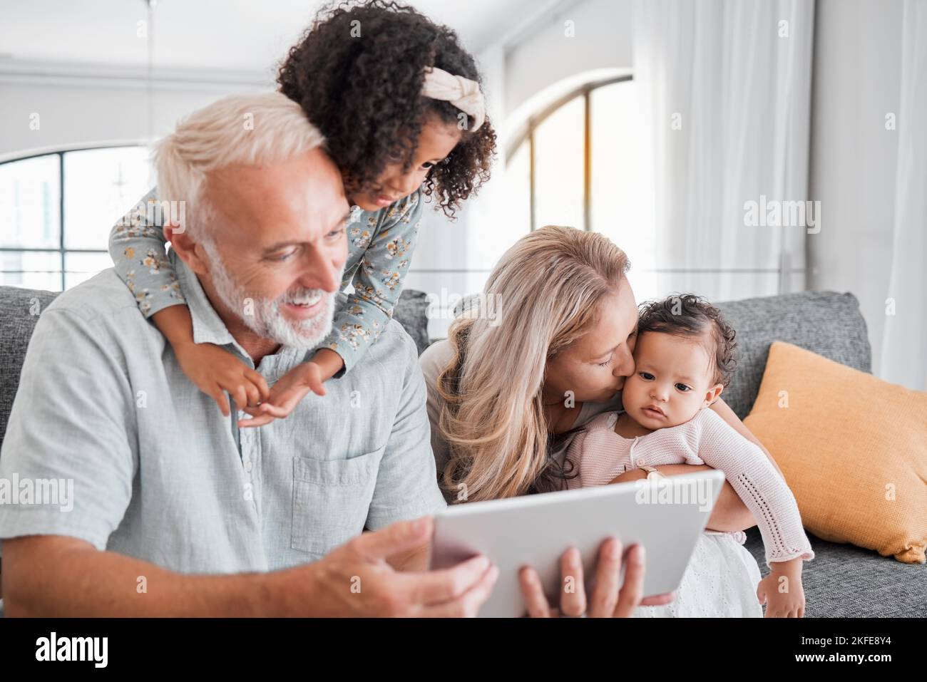 Tablet, family diversity and happy grandparents, children and baby ...