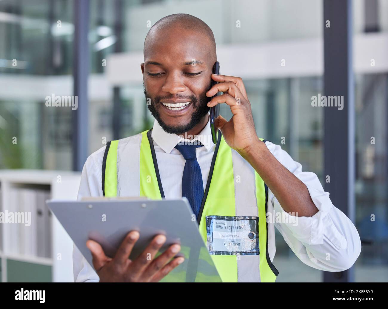 Black man with clipboard, phone call for communication during ...