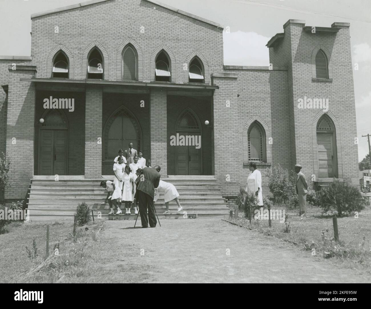 Ushers of an African American church standing on church steps and ...