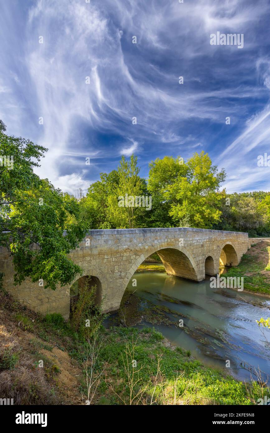 Romanesque bridge of Artigue and river Osse near Larressingle on route ...
