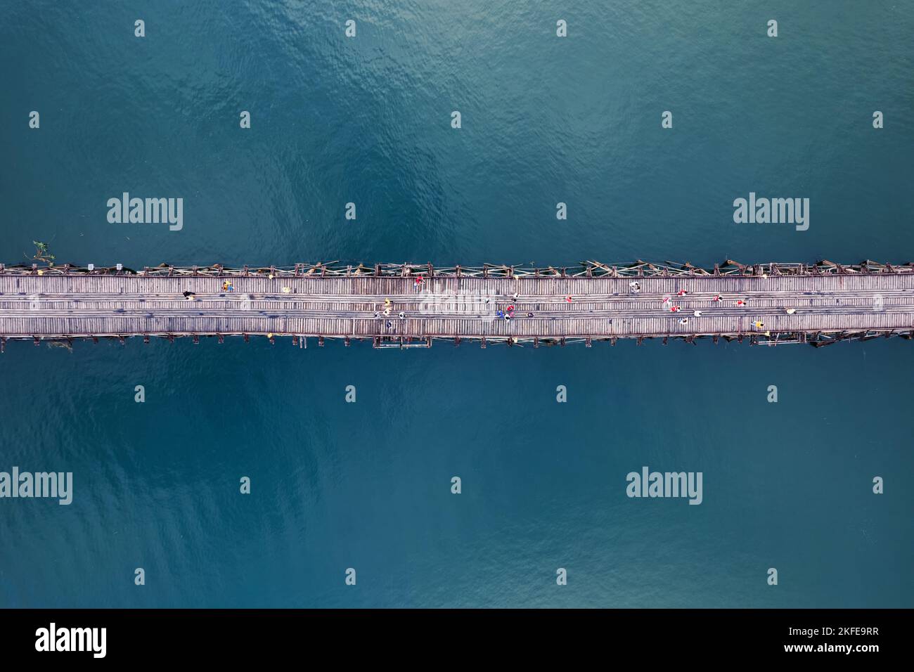 Above of ancient wooden Mon bridge with tourist walking over the dam in ...