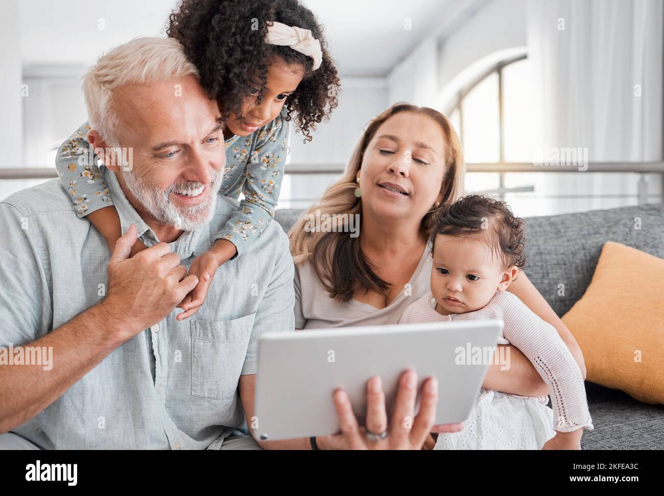 Relax, tablet and grandparents with children on sofa for movie, cartoon ...