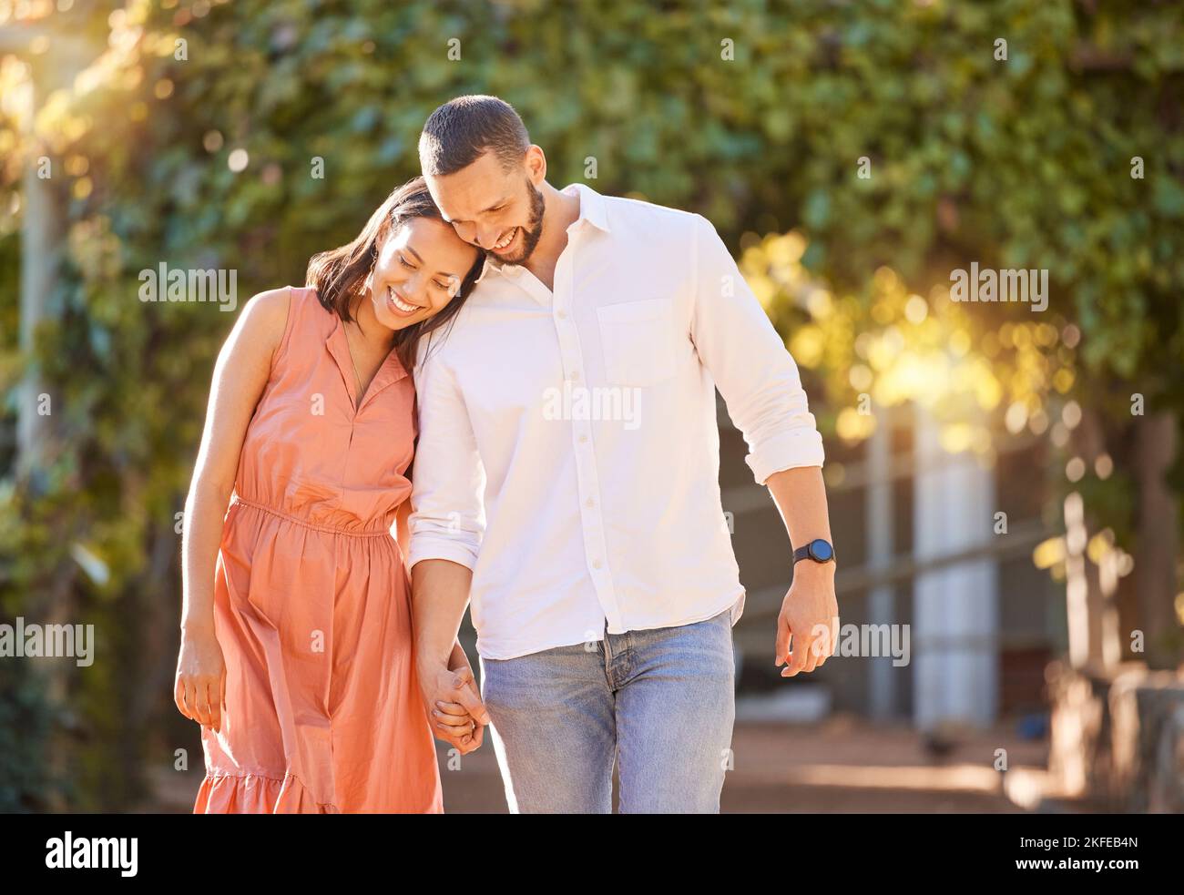 Couple, holding hands and bonding with love in a garden or park in ...