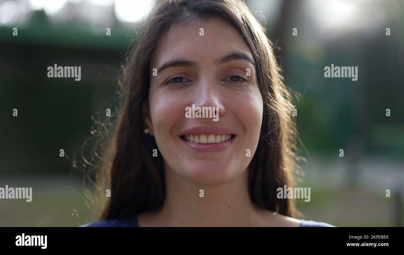 Happy woman opening eyes to camera smiling. Contemplative person with ...