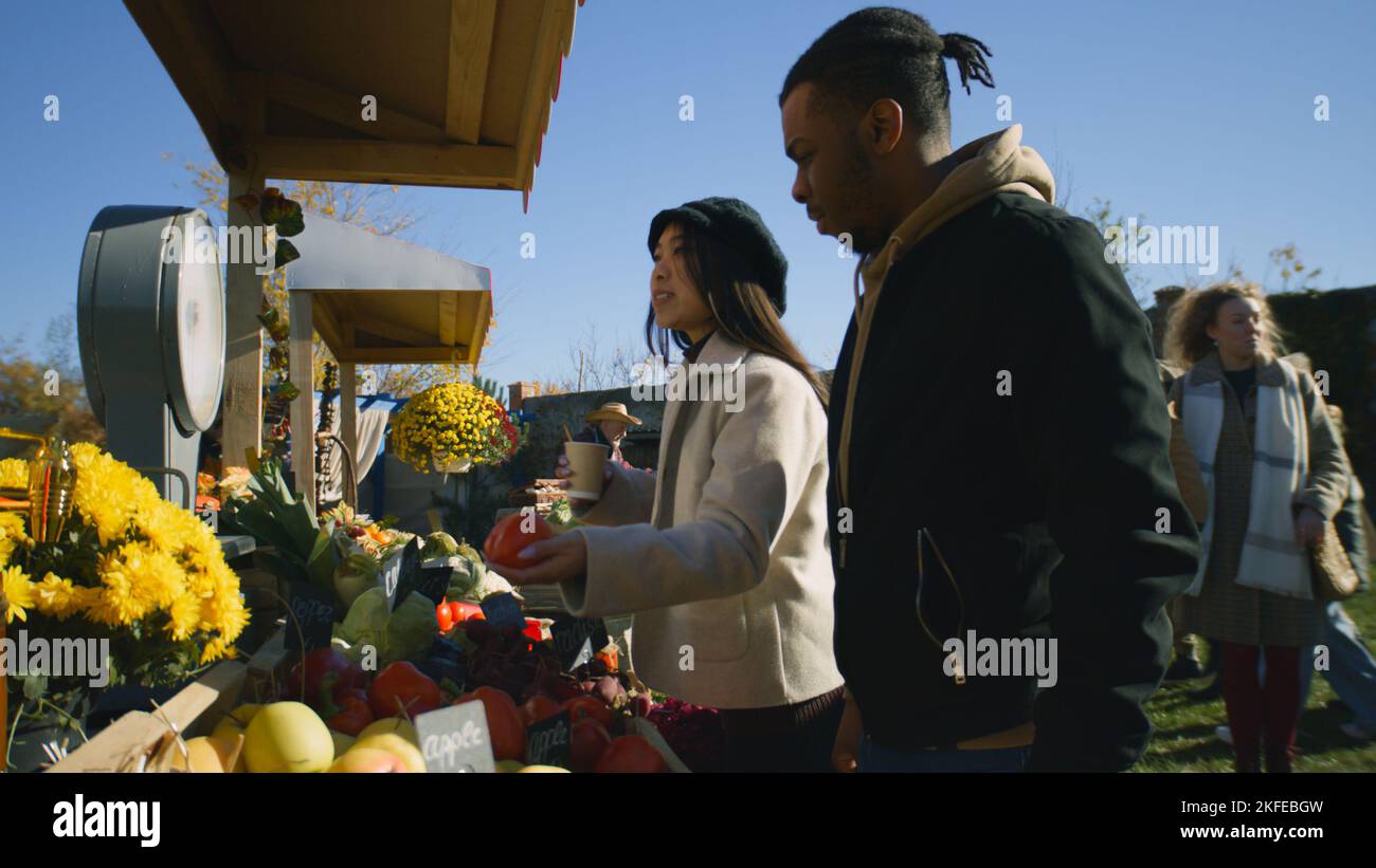Diverse couple shopping local farmers hi-res stock photography and ...