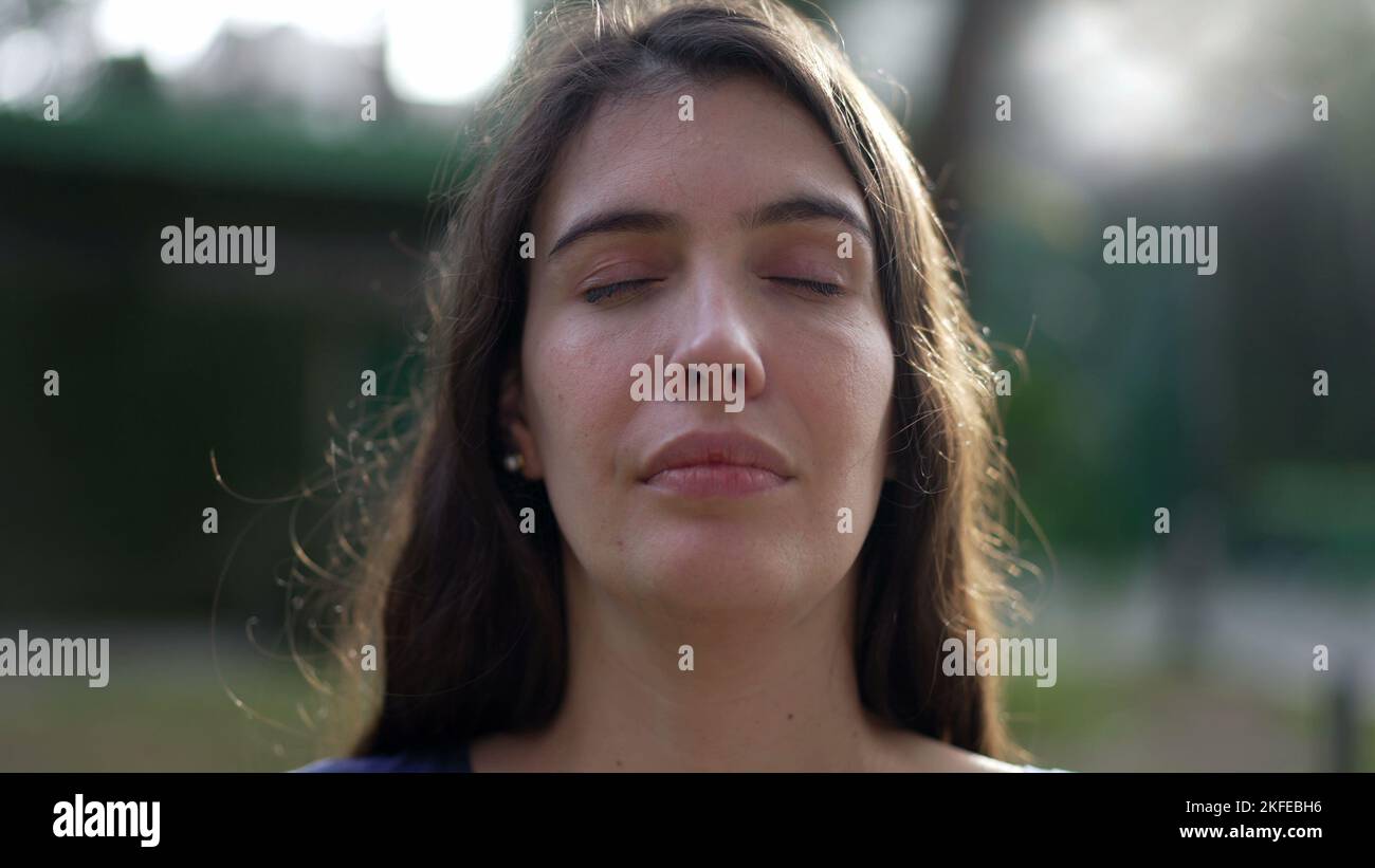 Happy woman opening eyes to camera smiling. Contemplative person with ...