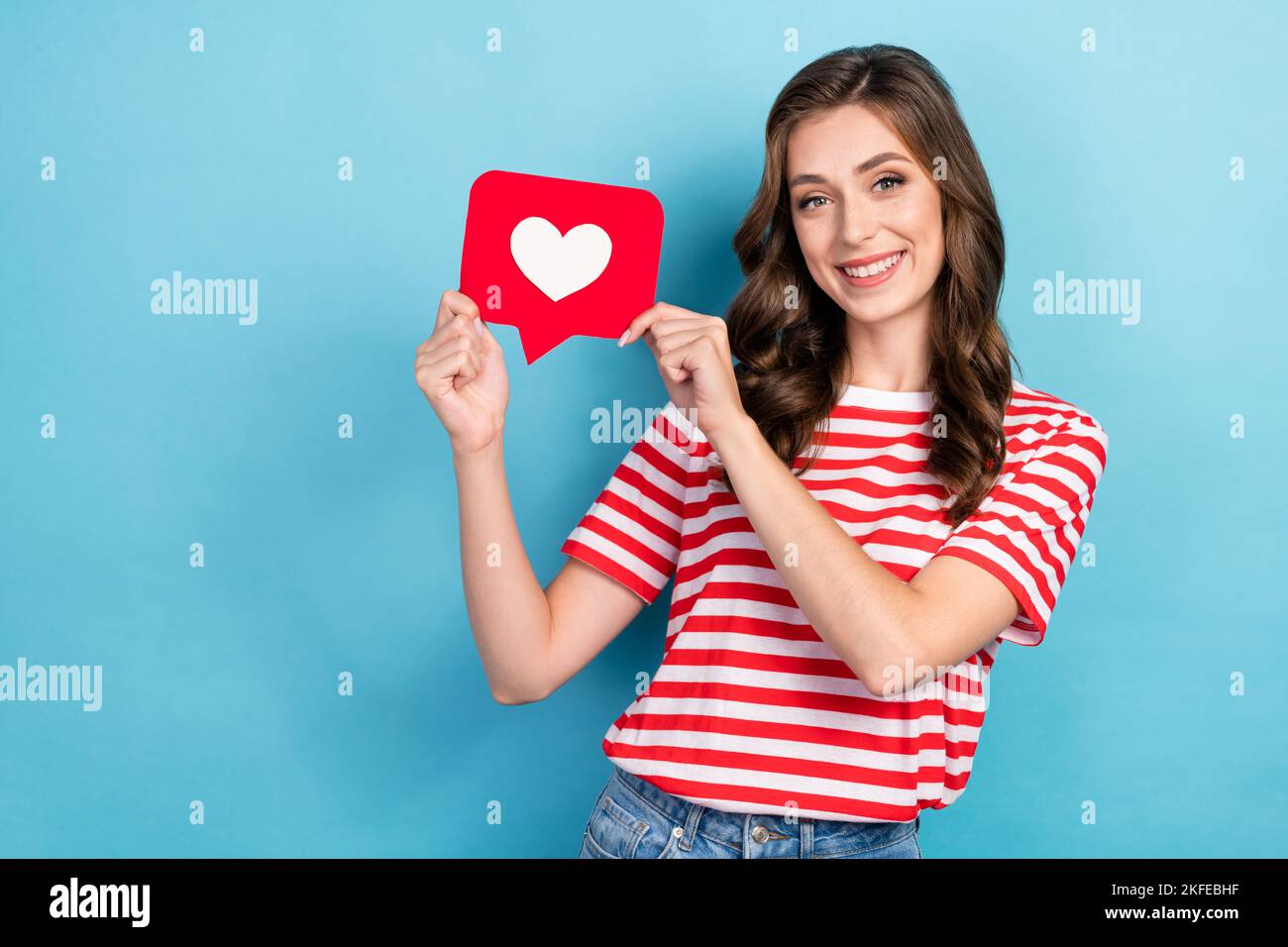 Photo of sweet adorable lady wear striped t-shirt holding heart like ...