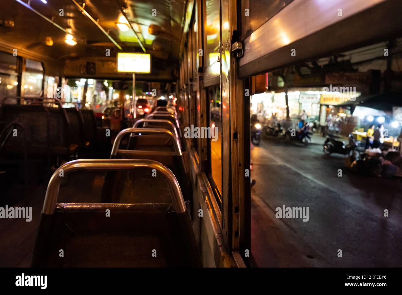 Ride in an empty bus through the city at night. City bus interior ...