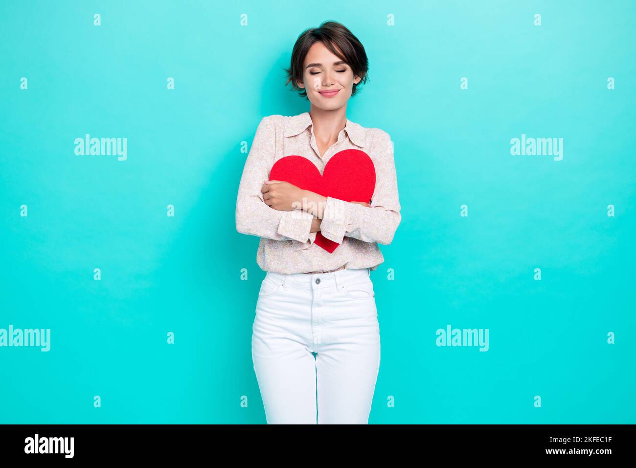 Photo of pretty sweet stylish lady eyes closed hug red paper card shape ...