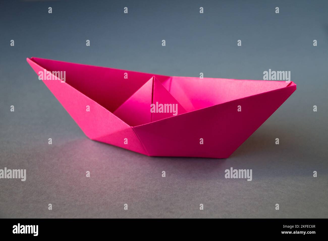 Pink paper boat origami isolated on a blank grey background Stock Photo ...