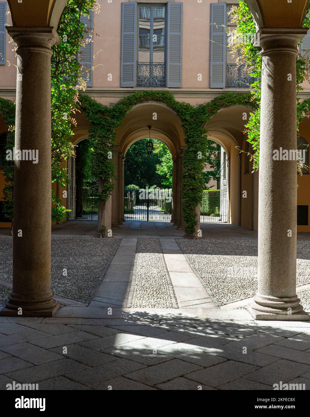 A closed garden with overgrown columns in France Stock Photo - Alamy