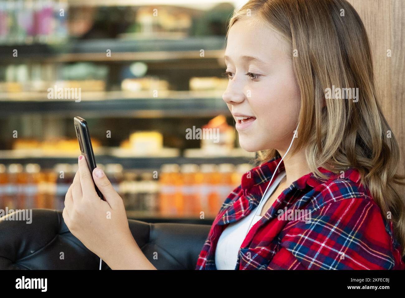 Happy teen girl using smartphone app enjoying online virtual chat video ...