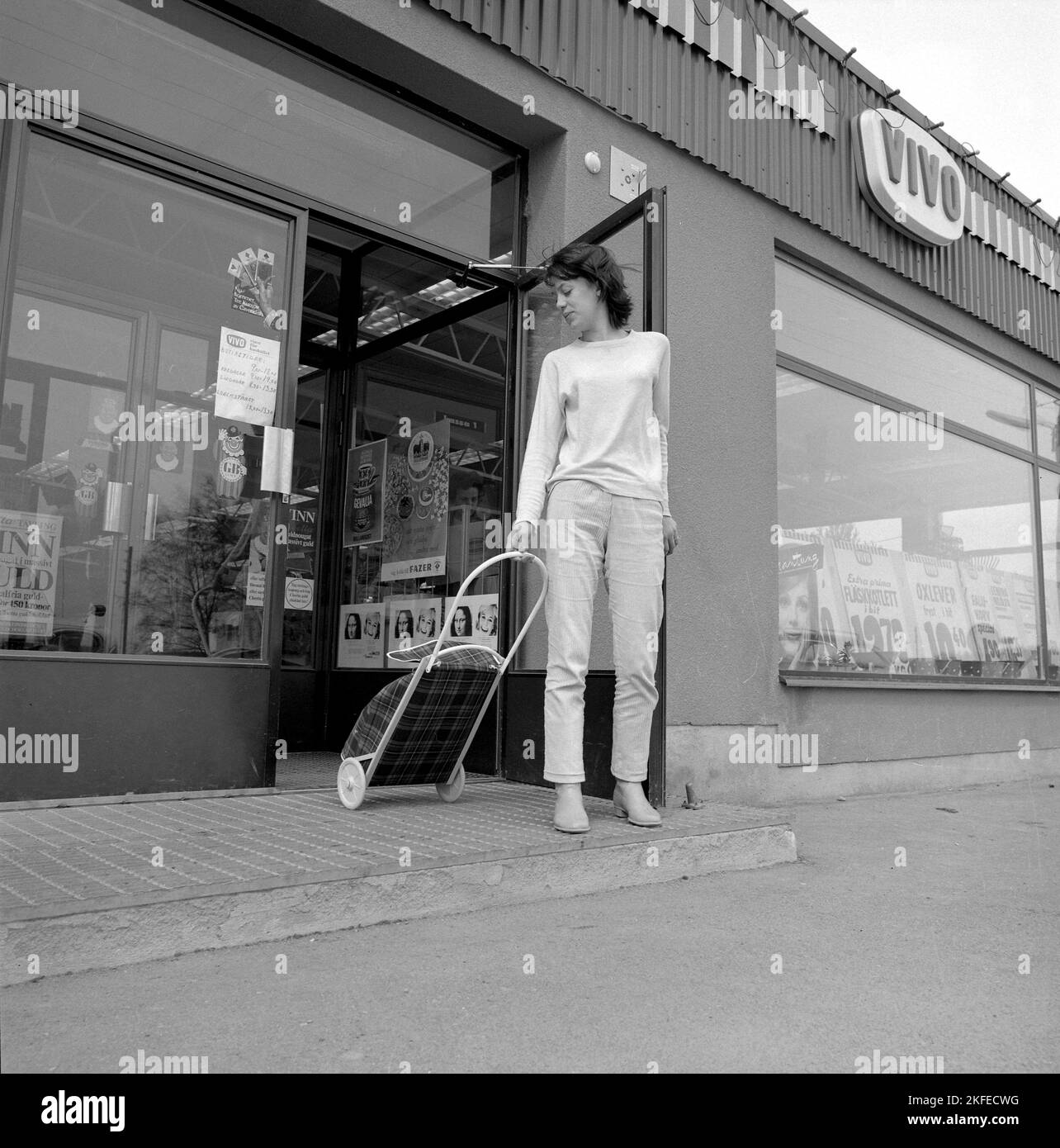Shopping In The 1960s A Young Lady At The Supermarket Where She Uses Her Shopping Cart For