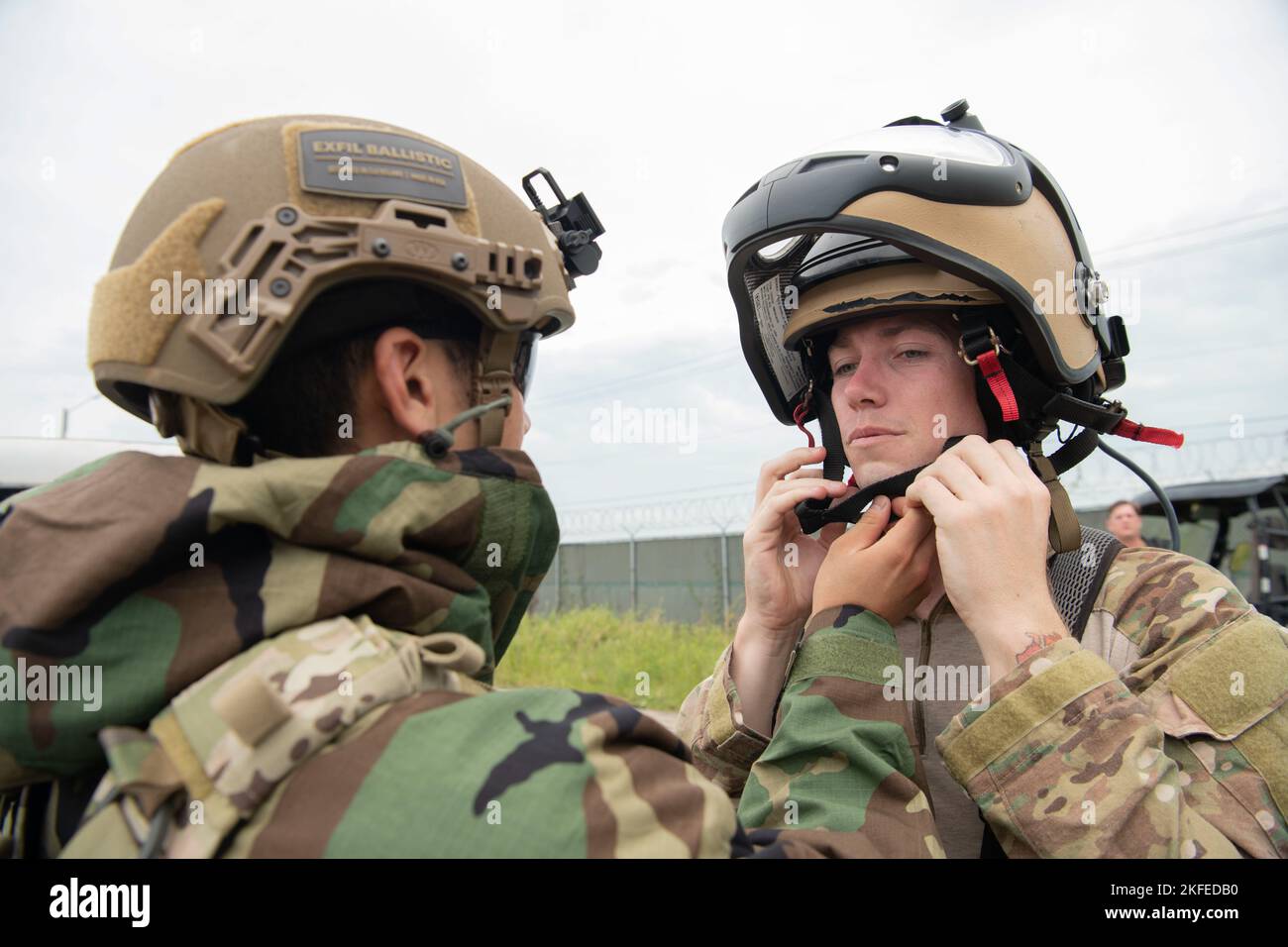 U.S. Air Force Senior Airmen Yung Kim (left), assists Jeremy Hoban ...
