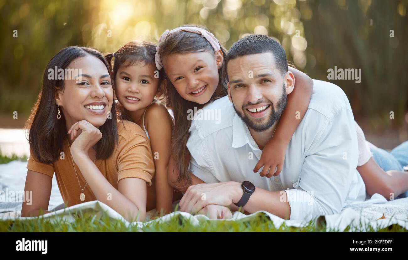 Portrait, picnic and family relax, smile and happy in nature park on ...