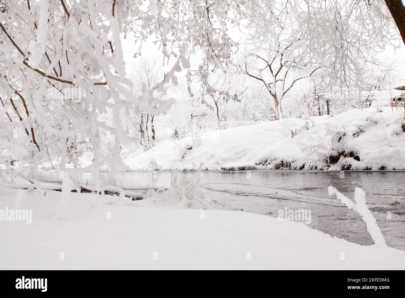 Snow-covered landscape of open spaces near the river. Snowy weather ...