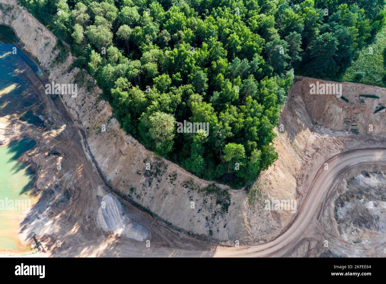 The slopes of a sand pit on the border with the forest, aerial view ...